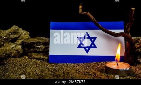 Israeli flag and burning candles in front of it, Holocaust memory day ...
