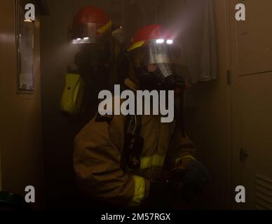 Navy Fire Control Technician 2nd Class Jean McKinney shows a torpedo to ...