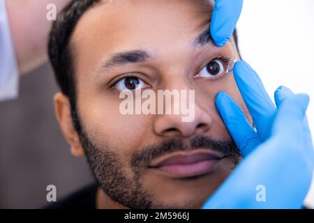 Ophtalmologist dropping eye drops to patients eyes Stock Photo - Alamy