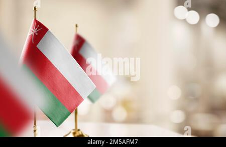 Small flags of the Oman on an abstract blurry background Stock Photo ...