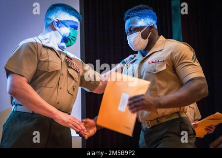 U.S. Marine Corps Col. Thomas Davis, right, promotes Maj. Learlin J ...