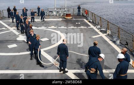 MALLACA STRAIT (Feb. 20, 2022) Sailors restow line below decks on the ...