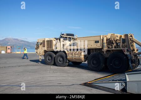 A vehicle is downloaded off the Army Prepositioned Stock-3 vessel, also ...