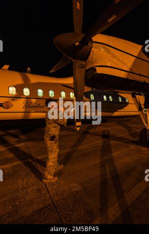 A crew chief of a UH-60 Blackhawk provides safety instructions to Joint ...