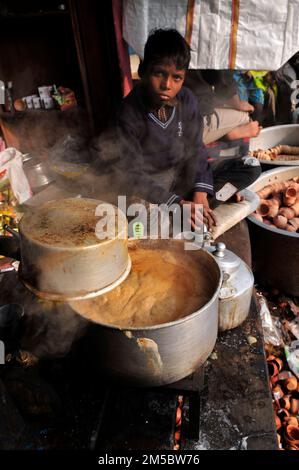 A Bengali boy preparing Chai - Indian milk tea. Kolkata, India Stock ...