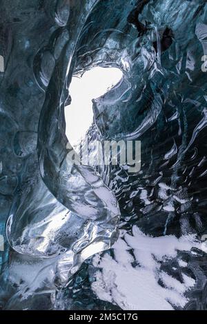 Ice cave open to the top with snow-covered ice combs, Proeng ice cave ...