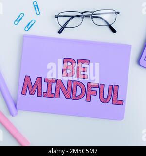 Hand writing sign Be Mindful, Word Written on paying close attention to ...