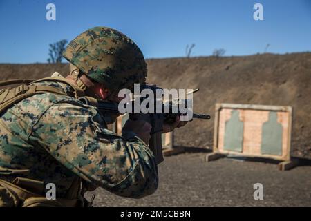 U.S. Marine Corps Warrant Officer Kyle Couts fires an M240B during the ...