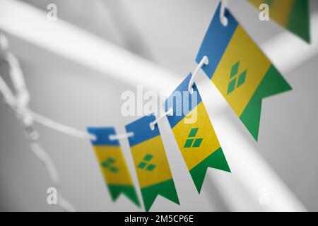 A garland of Saint Vincent national flags on an abstract blurred ...
