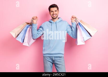 Photo of excited pretty guy dressed yellow pullover rising arms smiling ...