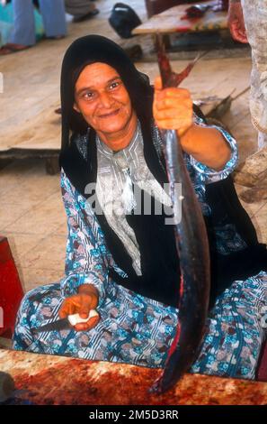 A fishmonger shows his wares Stock Photo - Alamy
