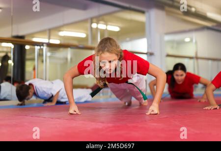 Preteen girl doing push-ups Stock Photo - Alamy