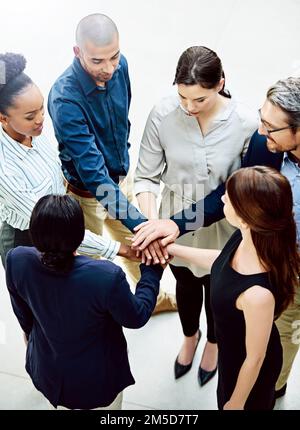 Group of smiling business people piling up their hands together Stock ...