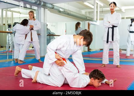 Boys performing arm lock movement during karate training Stock Photo ...