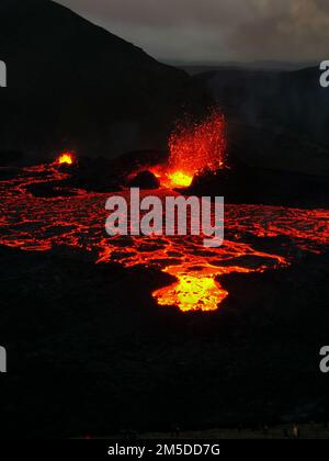 A volcano with lava pouring into the air from a crater Stock Photo - Alamy