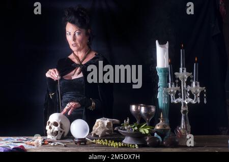 A dark, attractive witch practising her craft - John Gollop Stock Photo ...