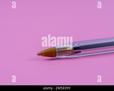 Ballpoint pen refill with ink ball writes on paper very close up Stock ...