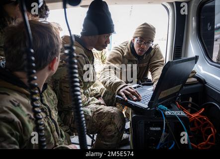 Airmen assigned to the 1st Combat Communications Squadron load cargo ...