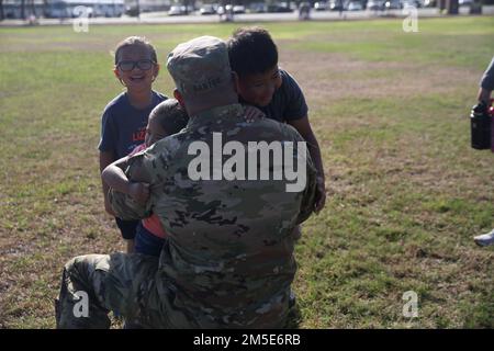 A 3rd Division Sustainment Brigade Soldier greets his family during a ...