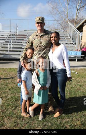 A 3rd Division Sustainment Brigade Soldier greets his family during a ...