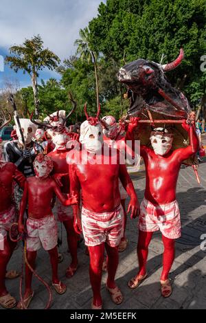 Painted devil dancers in costume at a parade for the Guelaguetza folk ...