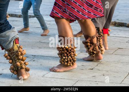 Ayoyote nut rattles on the ankles of a Zapotec dancer in a square in Oaxaca, Mexico during the ...