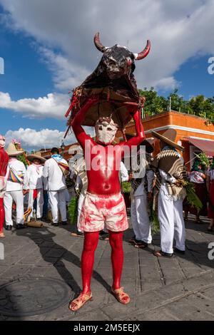 Painted devil dancers in costume at a parade for the Guelaguetza folk ...