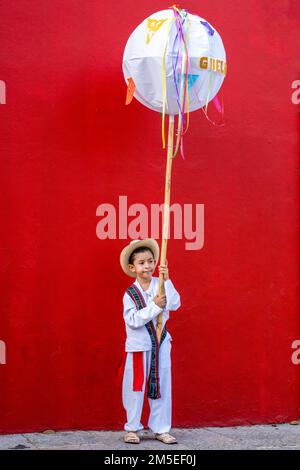 A portrait of a young farolero dancer from the Chinas Oaxaquenas dance ...