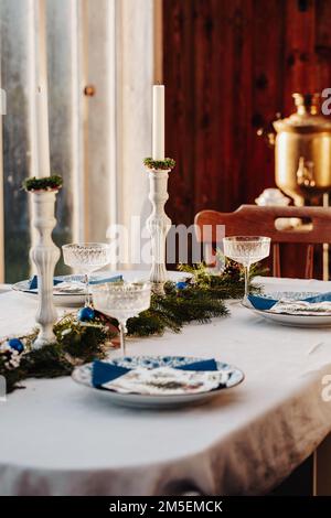 Christmas table setting on the veranda Stock Photo - Alamy