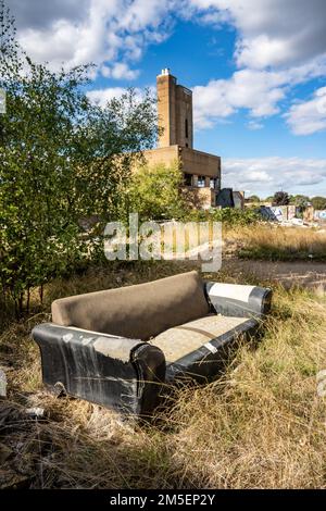 Sofa fly tipped on an abandoned airfield Stock Photo - Alamy