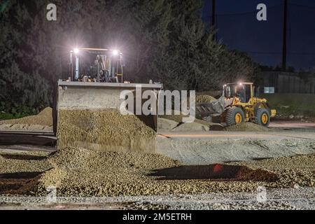 Two front-end loaders from the 18th Civil Engineer Squadron flatten and ...
