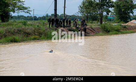 A Royal Thai Army soldier is pulled across a waterway by his squad ...