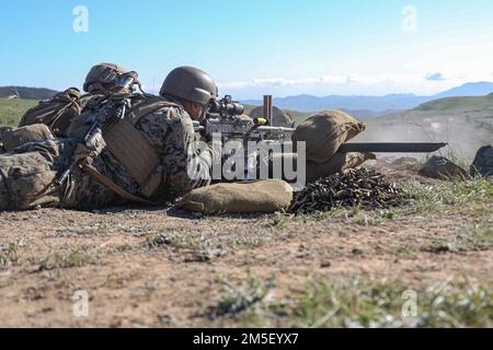 Marine Corps machine gunner fires an M60 machine gun from an AMTRAC ...
