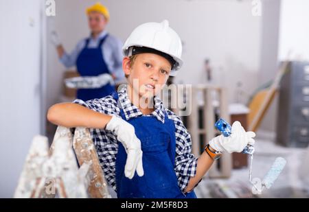 Boy posing with tools for home renovation Stock Photo - Alamy