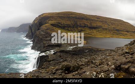 Bøsdalafossur waterfall of Leitisvatn lake to the ocean Stock Photo - Alamy