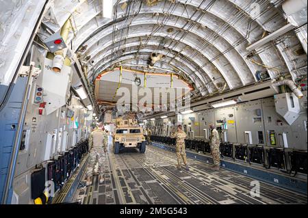 A Humvee is loaded onto a C-17 Globemaster III during an exercise to ...