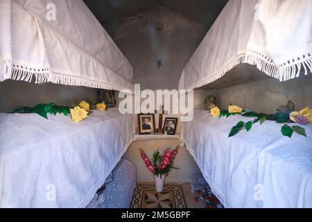 A view of various family members' coffins, caskets, stacked in their ...