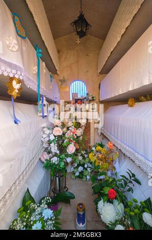 A view of various family members' coffins, caskets, stacked in their ...