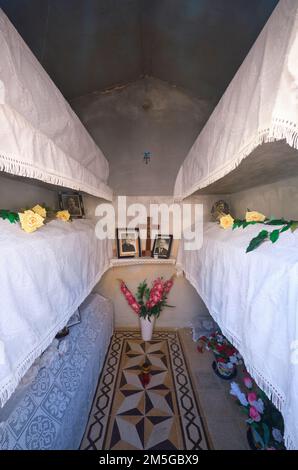 A view of various family members' coffins, caskets, stacked in their ...