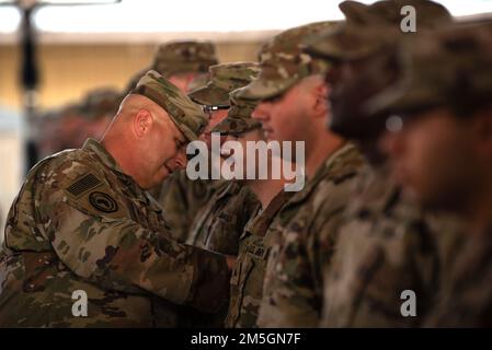 Members of the 404th Maneuver Enhancement Brigade listen to Maj. Gen ...