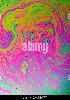 Colourful light diffraction patterns formed by oil droplets floating on ...