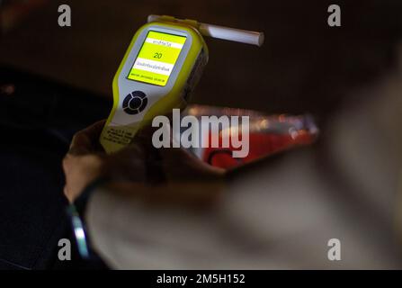 A Thai police officer shows the breathalyzer with a normal alcohol ...