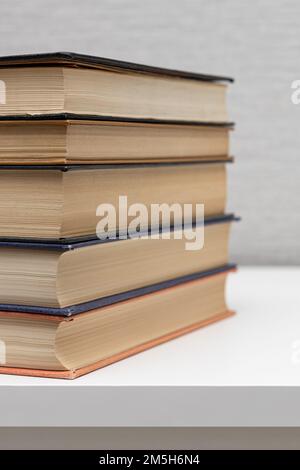 a stack of old books lies on the table. Old book. yellow book page ...