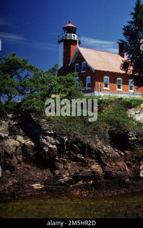 Copper Country Trail - Copper Harbor Lighthouse. Waves crash against ...