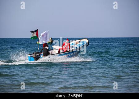 Palestinian surfers dressed in Santa Claus outfits surfing in ...