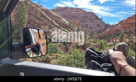 drying trekking boots from car window while driving Stock Photo - Alamy