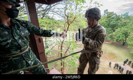 Soldiers of the Royal Thai Army ready their weapons and fire under the ...