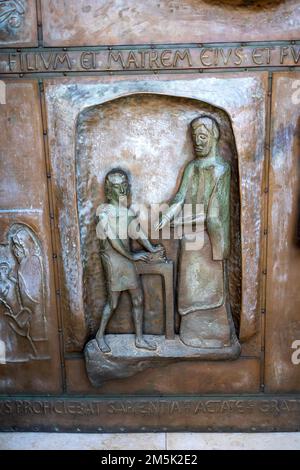 NAZARETH, ISRAEL December 2022: Iron door with bas-reliefs with ...