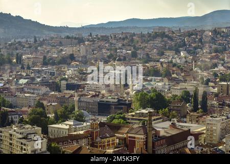 An aerial shot of Sarajevo city surrounded by hills and mountains ...