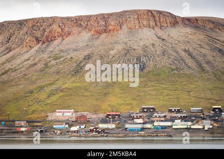 Hamlet of Arctic Bay on the shore of Baffin Island off Admiralty Inlet ...